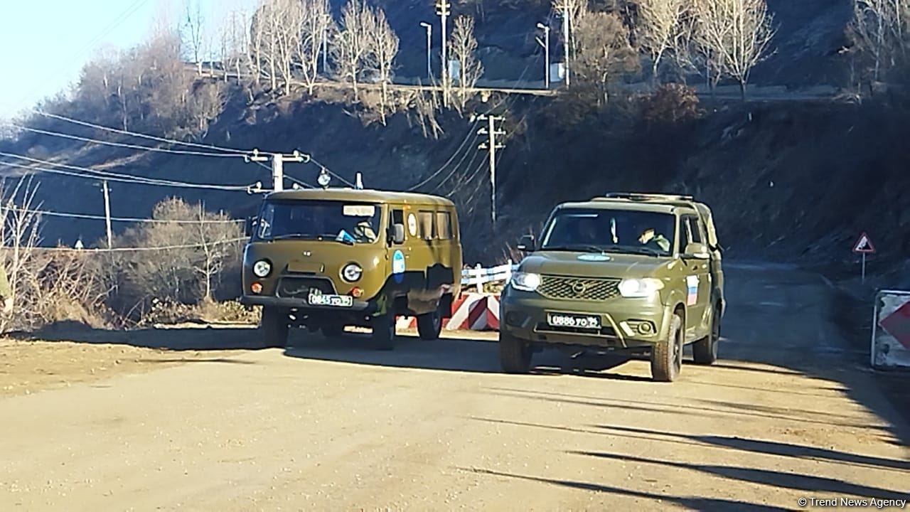 Several more vehicles of Russian peacekeepers pass freely along ...